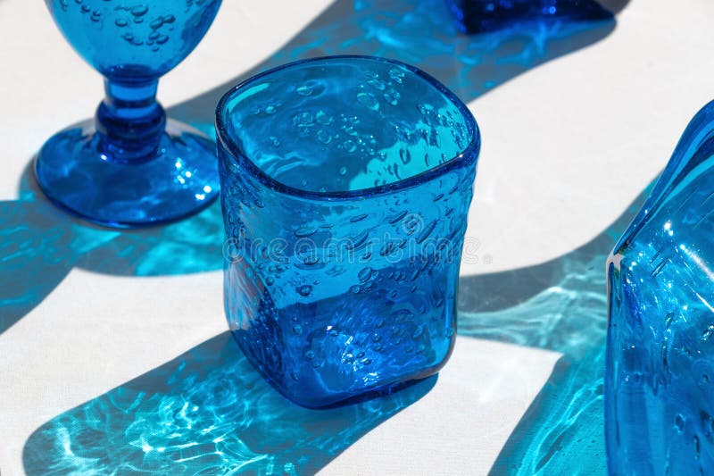 Vibrant Blue Glassware Casting Artistic Shadows on White Surface Stock ...