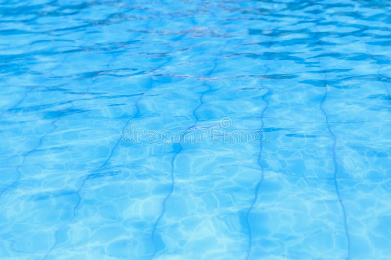 Vibrant Blue Pool Water with Rippling Reflections and Sunlight Patterns ...
