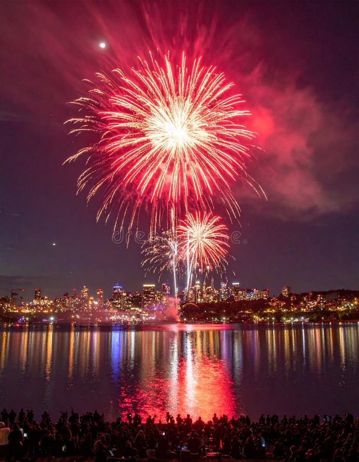 Vibrant Canada Day Fireworks Over City Skyline with Reflective Waters ...