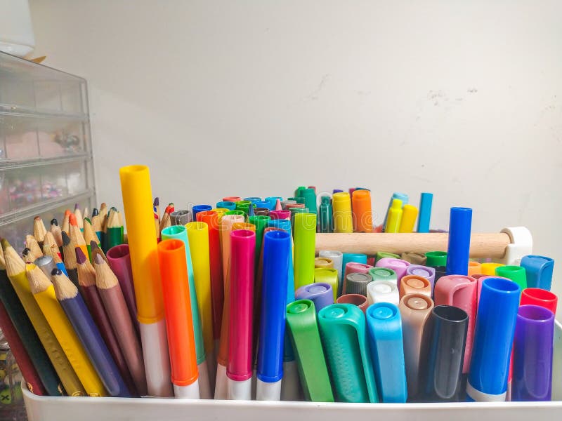Vibrant Collection of Colored Pencils and Markers in a White Container ...