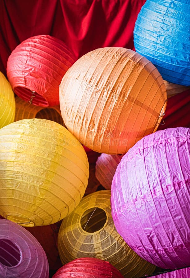 Vibrant Collection of Colorful Paper Lanterns on a Red Fabric Backdrop ...