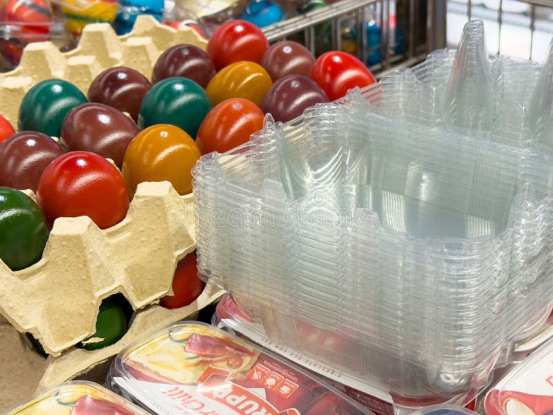 Vibrant Colored Eggs and Clear Plastic Packaging in Market Display ...