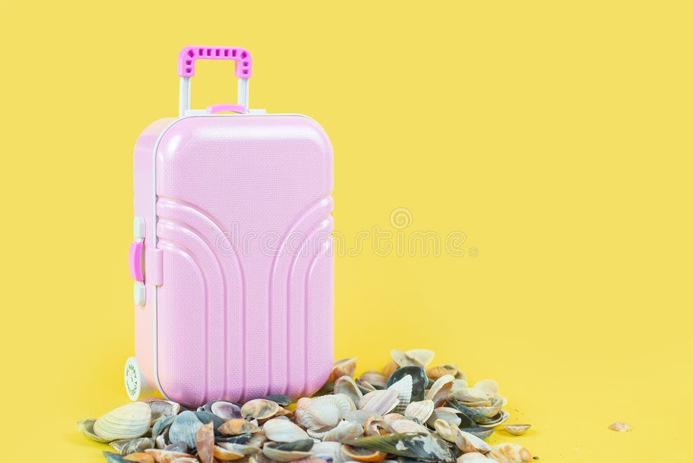 A Vibrant and Colorful Pink Suitcase Adorned with Seashells on a Bright ...