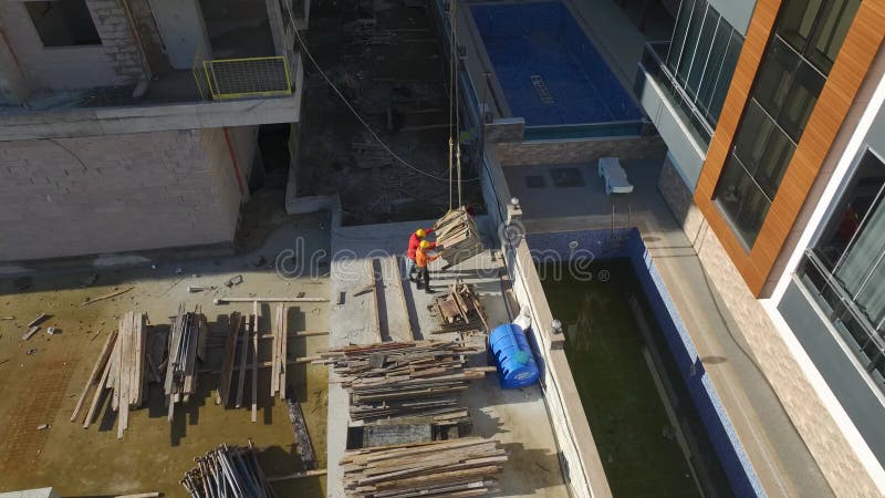 Aerial Video: Construction Progress Captured Vertically with Workers ...