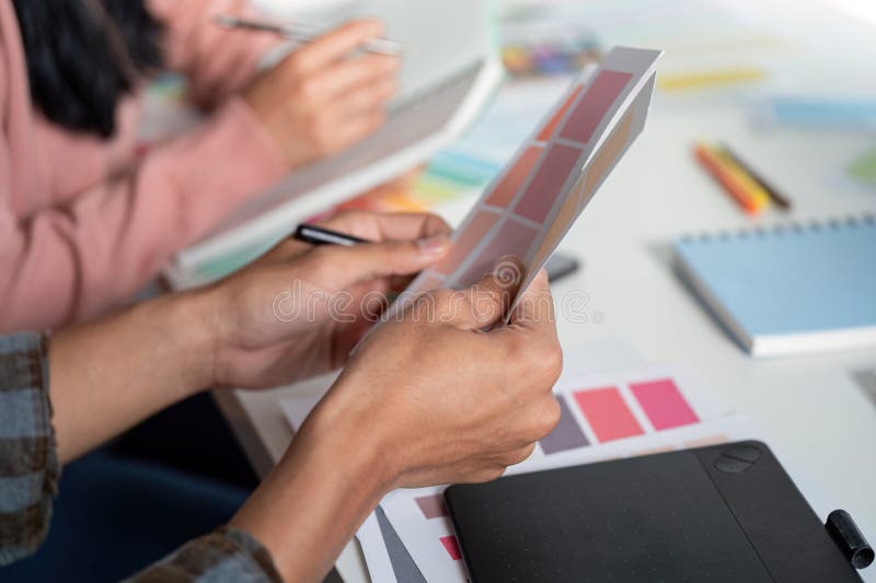 Design Team Collaborating on Graphics Development in Modern Office ...