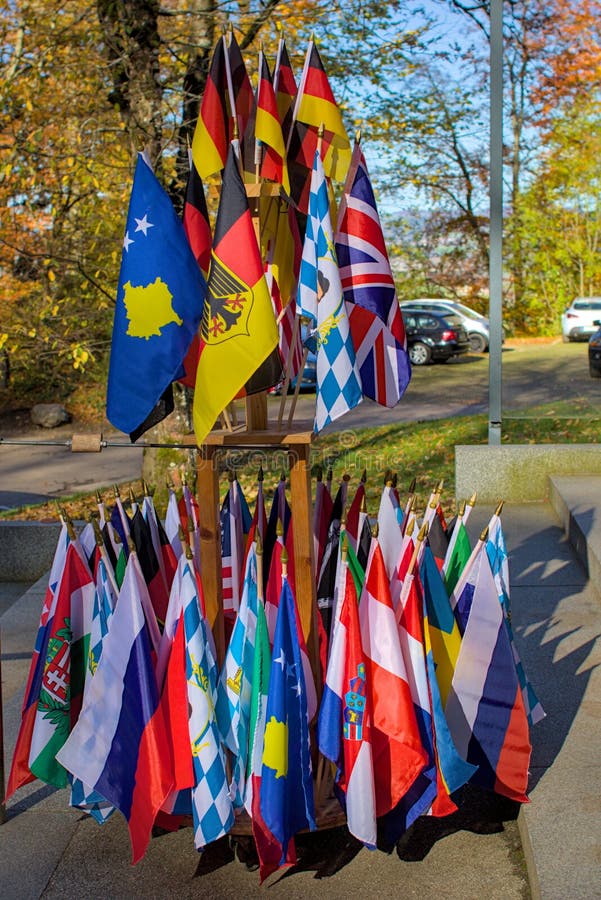 A Vibrant Display of Flags from Various Nations is Arranged on a Wooden ...
