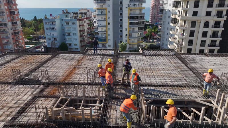 Aerial View: Concrete Pouring and Active Teamwork Define the ...