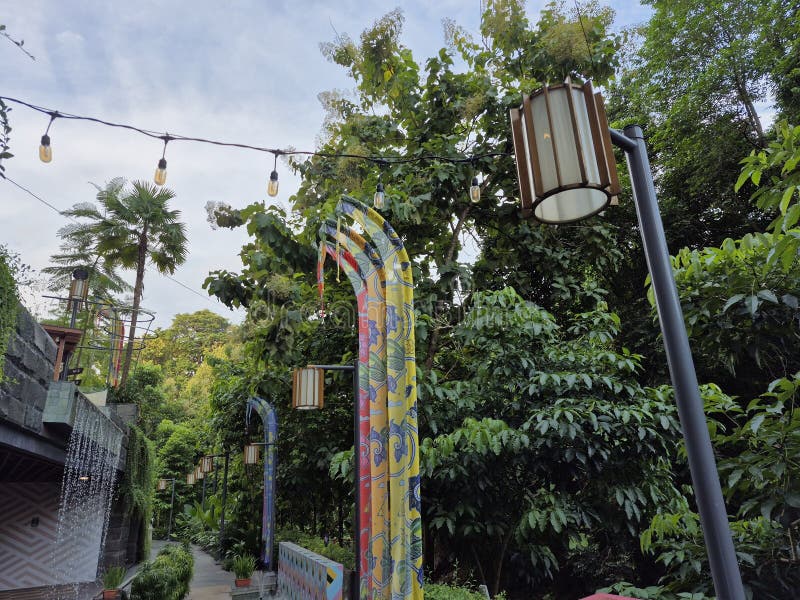 A Vibrant Garden Pathway Adorned with Colorful Vertical Banners and ...