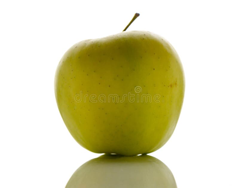 Vibrant Green Apple Standing on a Reflective Surface Under Bright Light ...