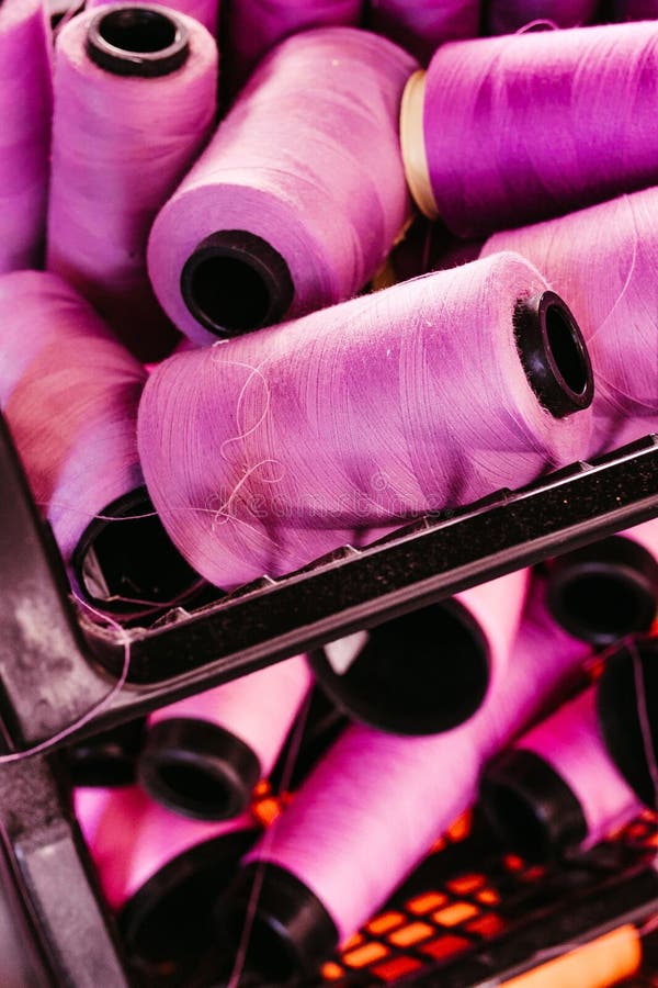 Vibrant Image of a Line of Pink Thread Spools, Arranged Vertically ...