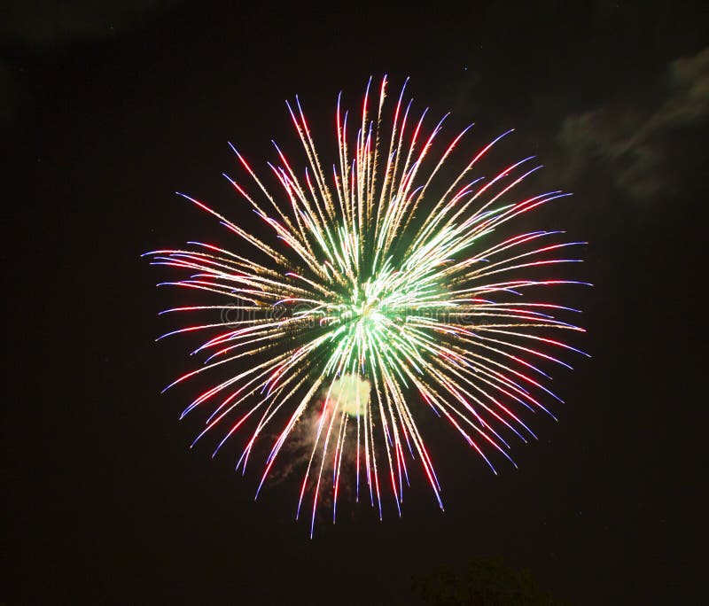 A Vibrant, Multi-colored Firework Explodes Against a Dark Night Sky ...