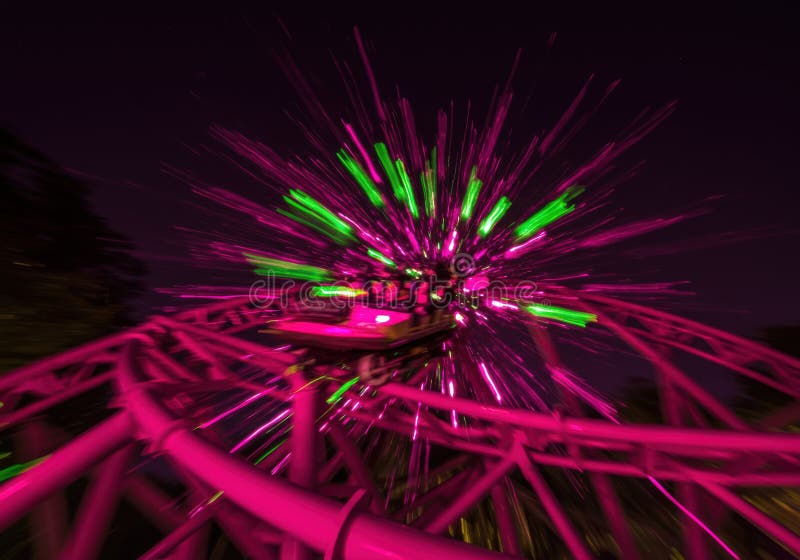 Vibrant Night Roller Coaster Ride with Neon Streaks and Thrilling ...