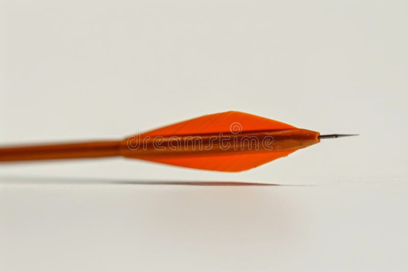 A Vibrant Orange Arrowhead Rests on a Smooth Surface during an Archery ...