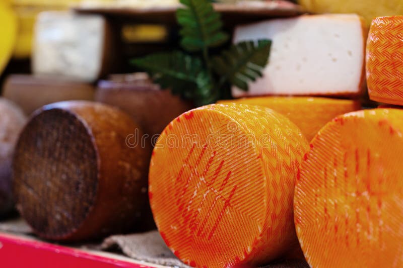 Vibrant Orange Cheese Wheels with Brown and White Cheese Stock Image ...