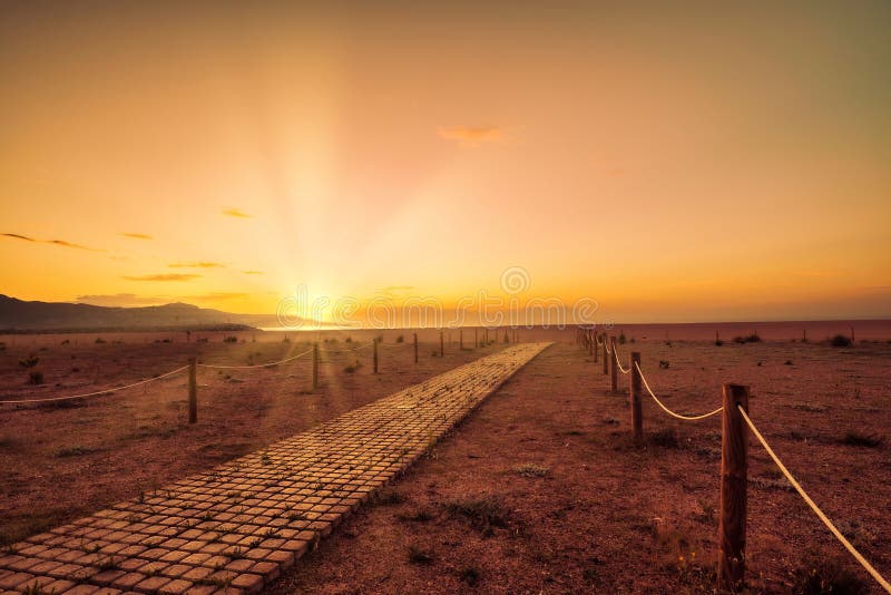Vibrant Orange Sunrise Creates a Stunning Backdrop To an Empty Desert ...