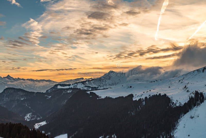 Vibrant Orange Sunset Over Snowy Mountains Stock Photo - Image of ...