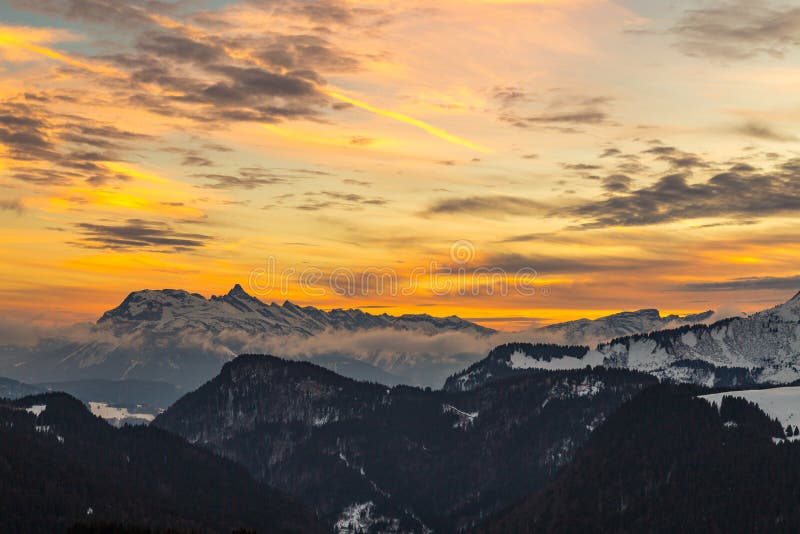 Vibrant Orange Sunset Over Snowy Mountains Stock Image - Image of hill ...