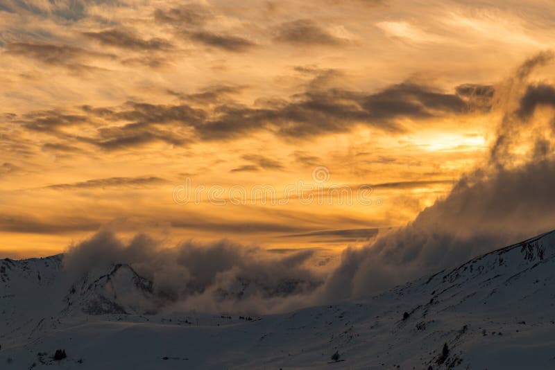 Vibrant Orange Sunset Over Snowy Mountains Stock Photo - Image of hill ...