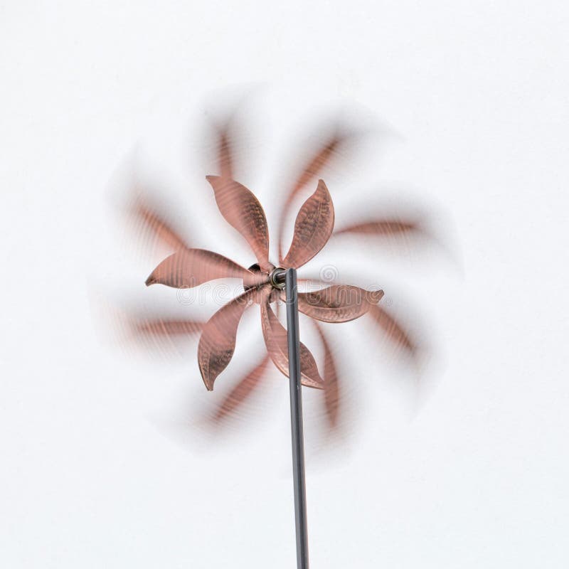 Vibrant Pink Metal Wind Spinner Suspended in Front of a Stark White ...