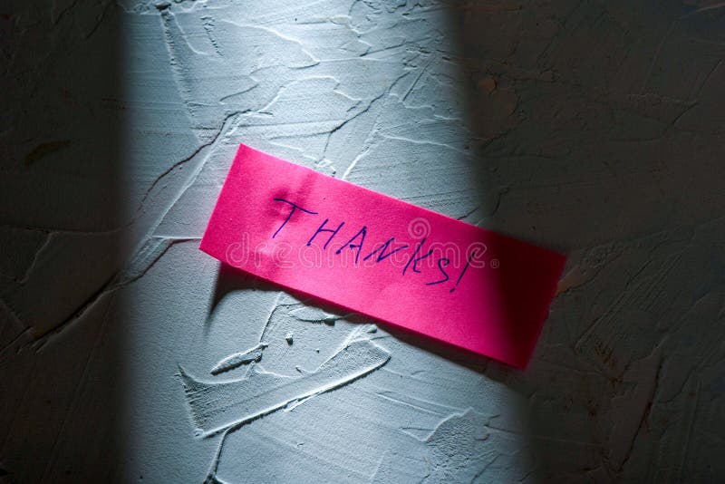 A Vibrant Pink Sticky Note Saying Thanks Placed on a Textured Wall ...