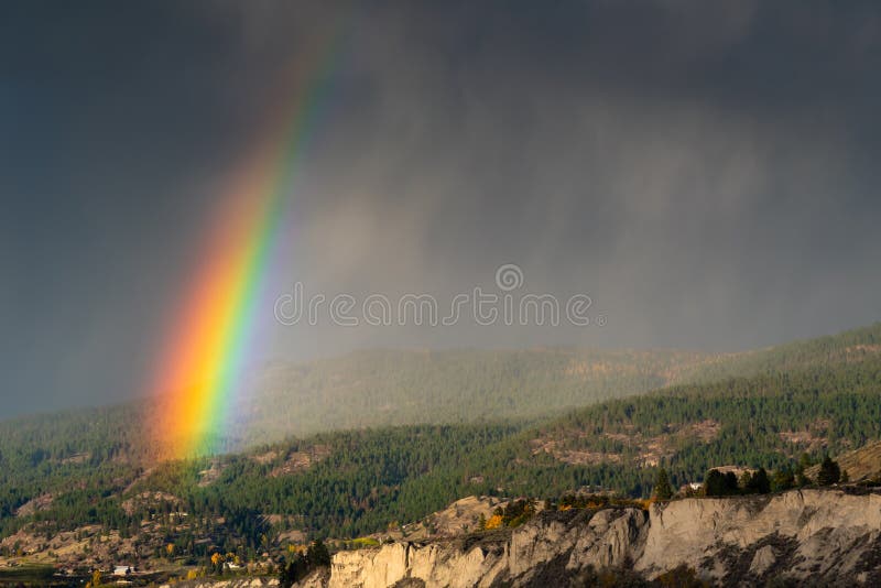 Vibrant Rainbow Shining through Storm Clouds and Falling Rain on ...