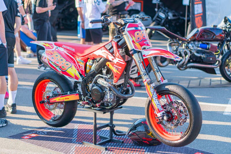 A Vibrant Red and Black Motorcycle on Display at an Exhibition or Event ...