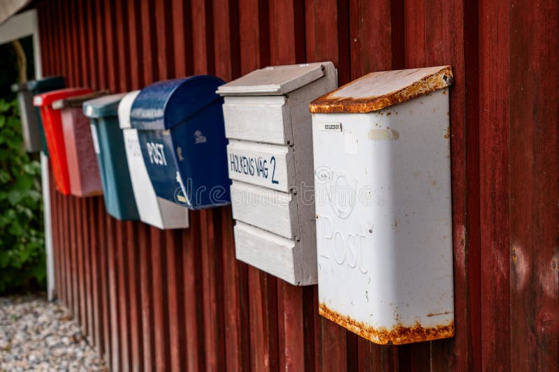 Vibrant Red Building with Mailboxes Stock Photo - Image of wall, post ...