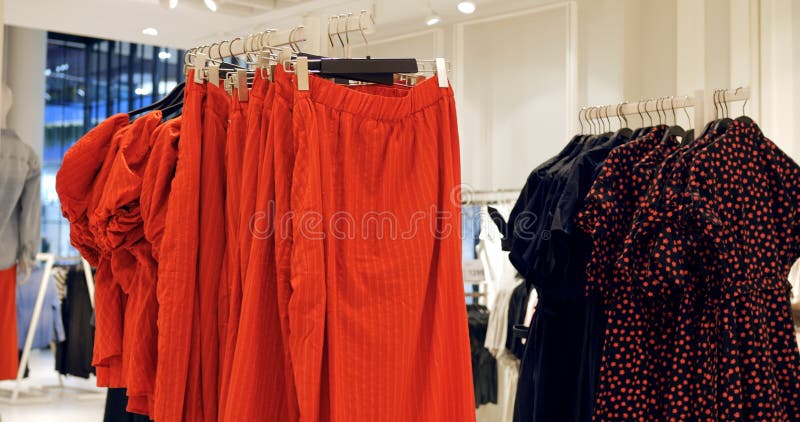 Vibrant Red Pants and Black Dresses Featuring Heart Patterns Hanging ...