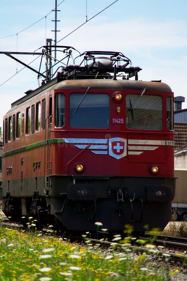 Vibrant Red Train Chugging Along Railway Tracks, Editorial Image ...