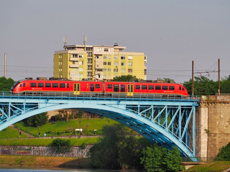 Vibrant Red Train Travelling Across a Bridge Stock Image - Image of ...