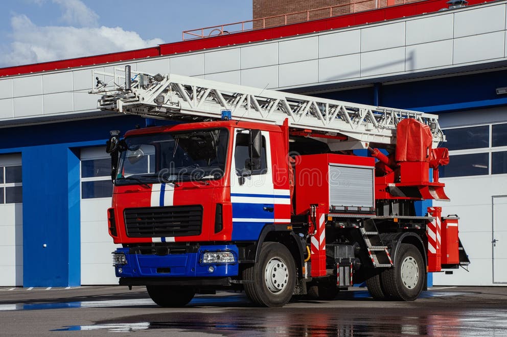 A Vibrant Red and White Fire Engine with an Extended Ladder is Parked ...