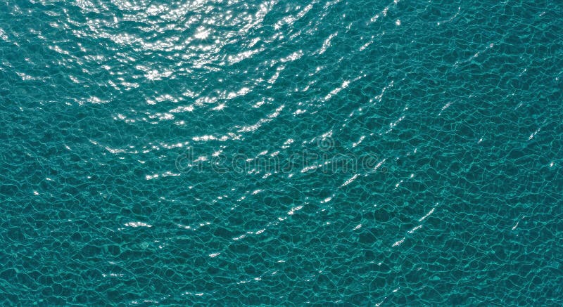 Vibrant Rippled Water Backdrop Featuring Sun Glints and Cyan Shading ...