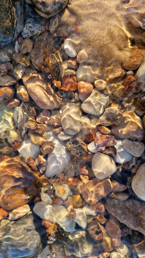 Vibrant River Pebbles in Clear Flowing Water Stock Photo - Image of ...