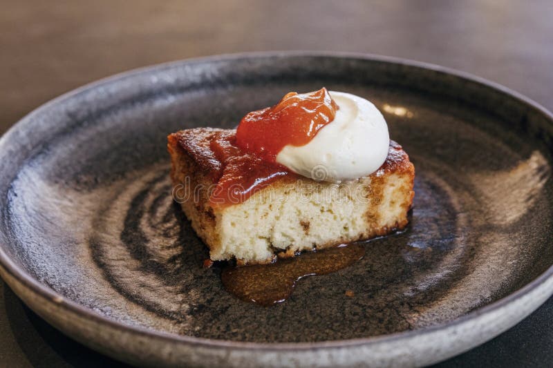 A Vibrant Slice of Malva Pudding Topped with Apricot Jam and Ice Cream ...