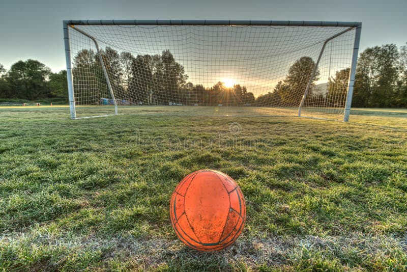 Vibrant Soccer Ball Centered in Front of Soccer Goal at Sunrise Stock ...