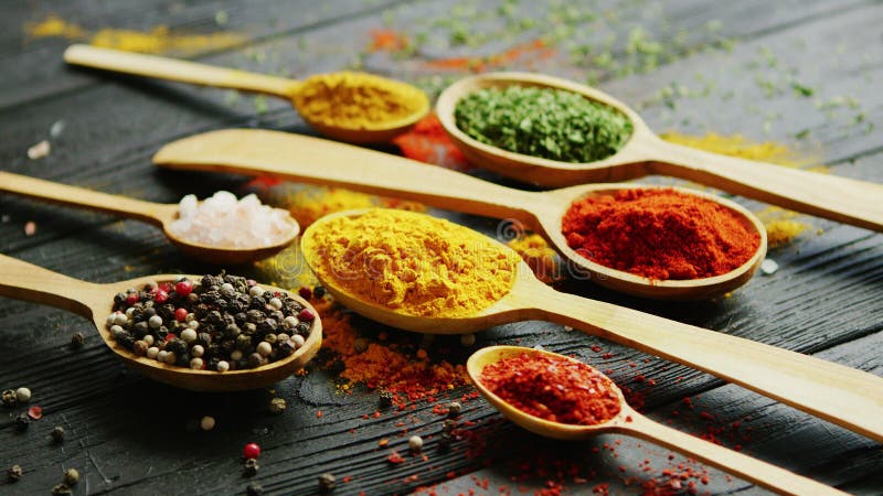 Vibrant Spices in Wooden Spoons on Rustic Table Stock Footage - Video ...