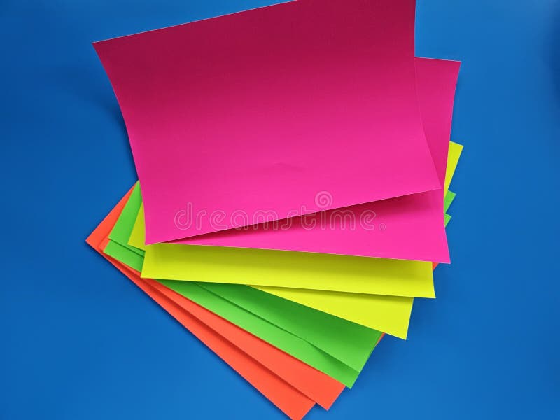 Vibrant Stack of Brightly Colored Sheets Arranged on a Blue Background ...