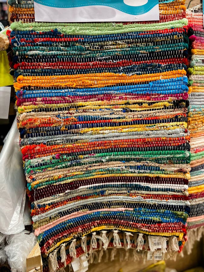 Vibrant Stack of Multicolored Woven Rugs Showcases a Blend of Textures ...