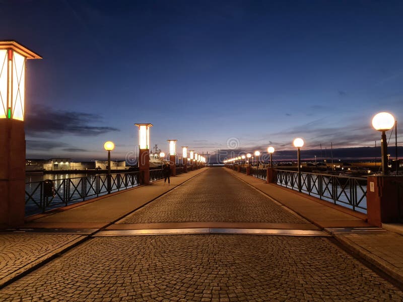 Vibrant Street Lanterns Illuminating the Bridge Pathway Over a River ...