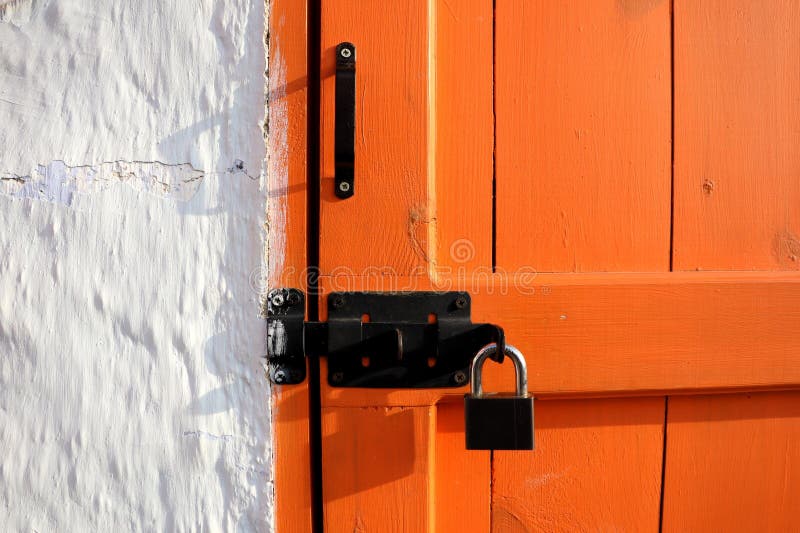 A Vibrant and Striking Orange Door, Complete with Lock and Multiple ...