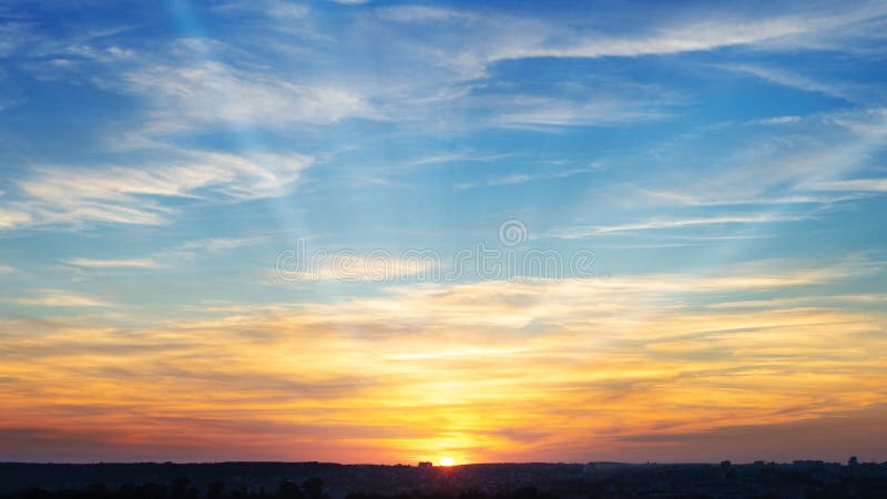 Vibrant Sunrise Sky Background of Orange and Blue Colours with Sunrays ...