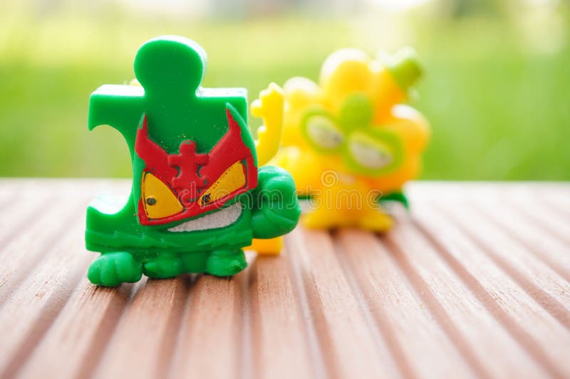 Vibrant Toy Figure Stands in Focus on a Wooden Surface Editorial Stock ...