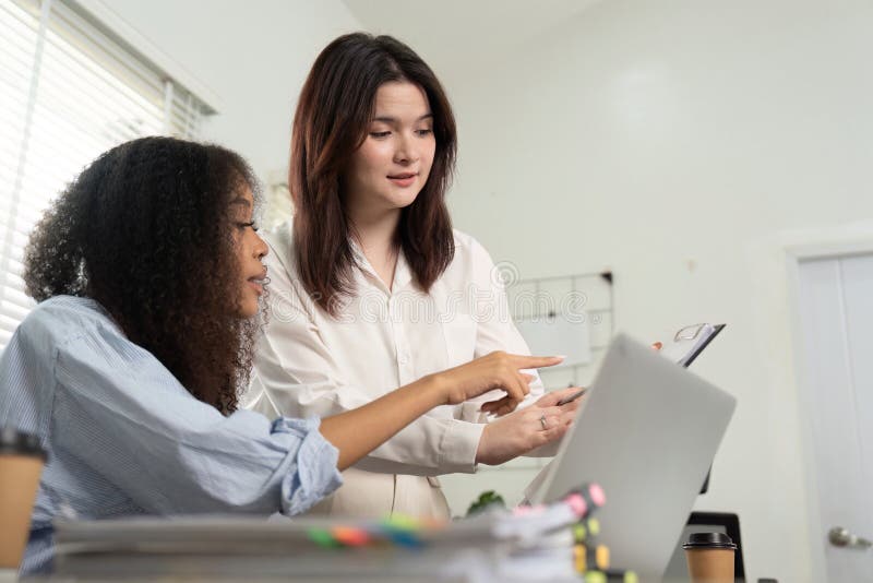 Collaborative Problem-Solving. Co-workers Pointing at a Laptop while ...