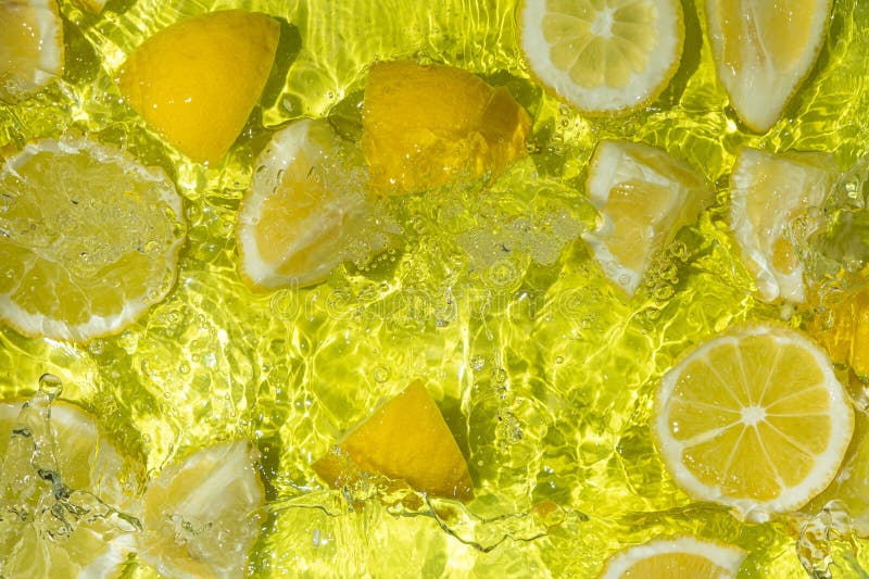 Vibrant Yellow Lemon Pieces Floating Motion Water Stock Photos - Free ...