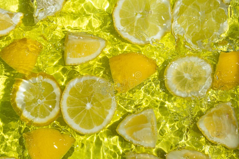 Vibrant Yellow Lemon Pieces Floating in Motion Water Stock Image ...