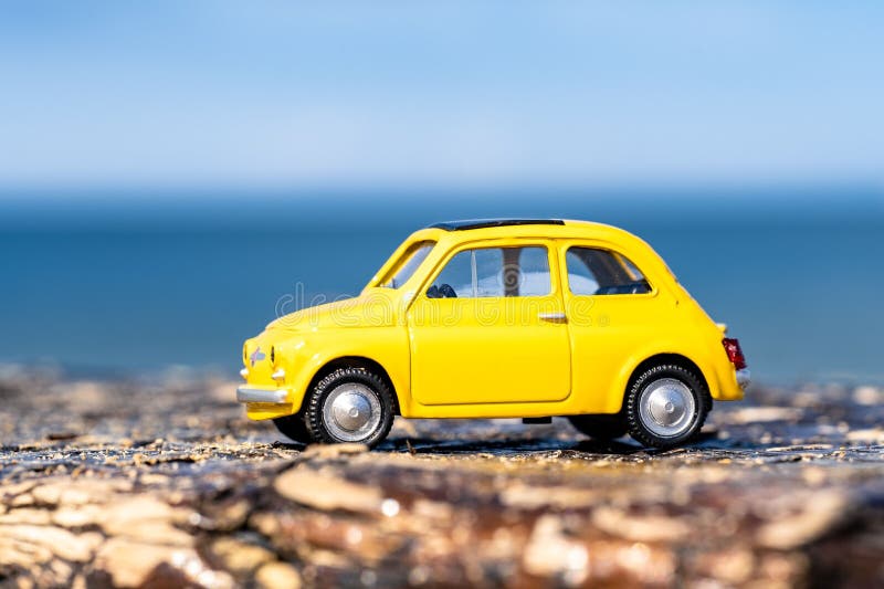 Vibrant Yellow Toy Car Parked on a Beach. Stock Image - Image of ...