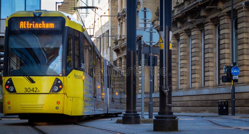 Vibrant Yellow Tram in the Streets of Manchester, UK. Editorial ...
