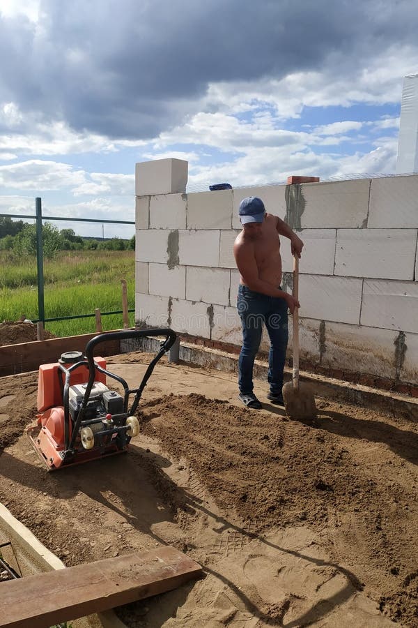 Vibrating Plate in Use, the Worker with the Help of a Vibrating Plate ...