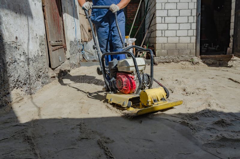 Vibratory Plate Construction Site. Construction Workers Installing and ...