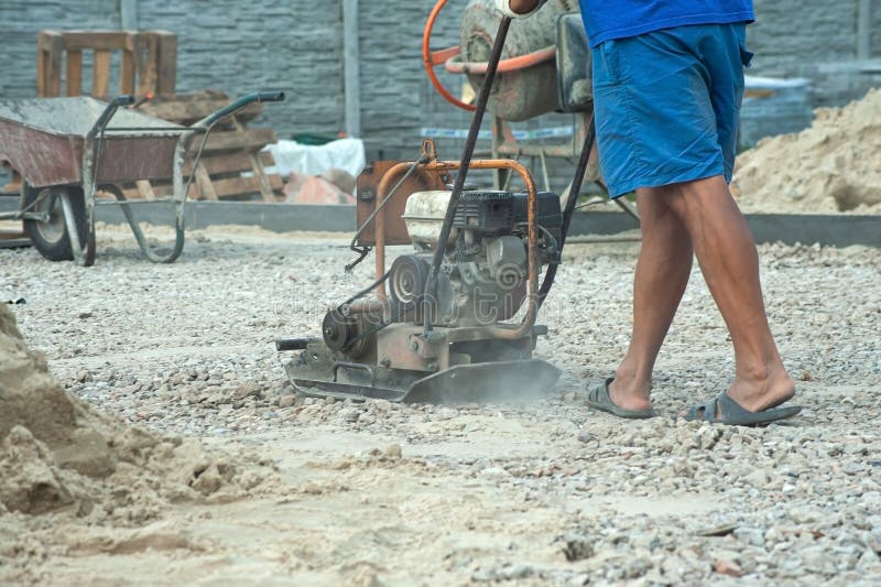 Vibratory Plate Construction Site. Construction Workers Installing and ...